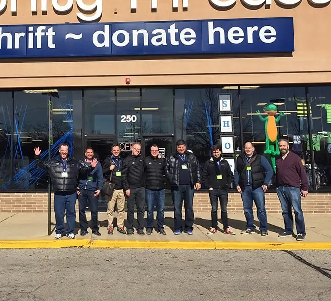 Community supporters gather outside the store, proving that thrifting isn't just shopping—it's a movement with passionate advocates.