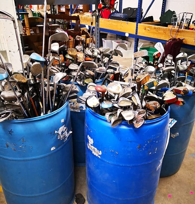 Golf club jackpot! These blue barrels hold more stories than a country club locker room—each dent and scuff a chapter in someone's sporting life.