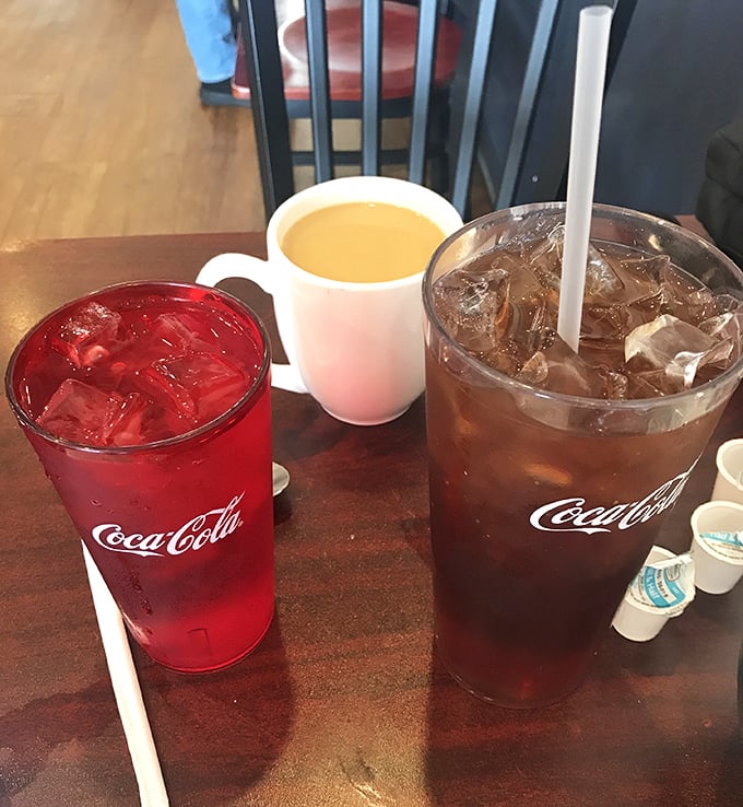 The holy trinity of diner beverages—cherry-red soda, coffee light enough to see through, and sweet tea dark as night—fueling conversations since forever.