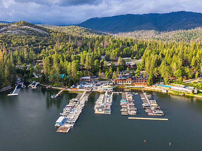 Bass Lake's perfect morning calm reflects the surrounding forest – nature's mirror at its finest.
