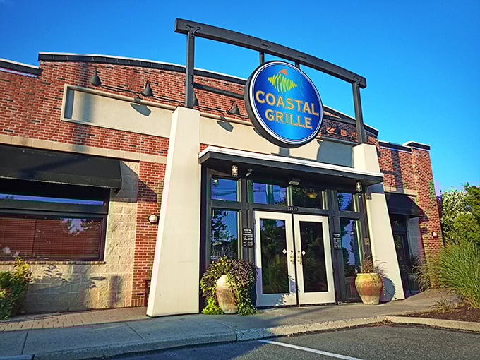 Coastal Grille's modern brick facade and distinctive blue sign offer a contemporary take on the seafood experience.