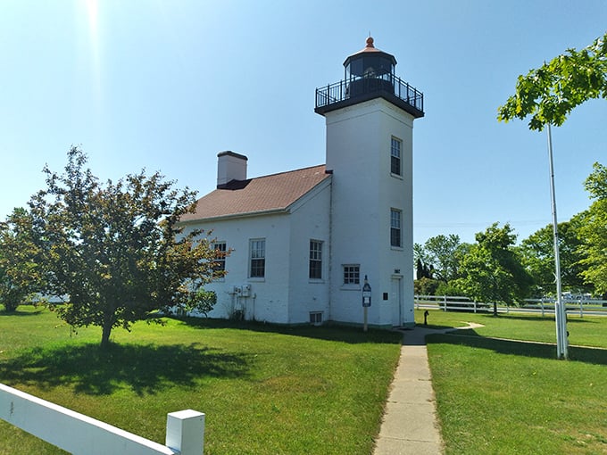 The historic lighthouse stands tall against the bright sky, offering timeless views and peaceful charm along Escanaba’s scenic waterfront.