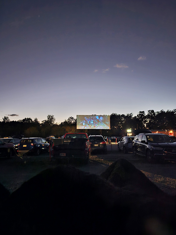 Hi-Road's concession stand glows with promise as the sky darkens. Where movie snacks taste better with a side of starlight.