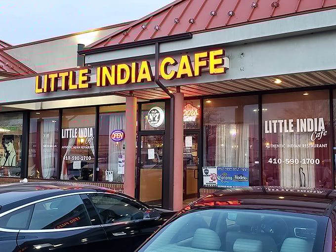 The evening lights make Little India Café glow like a jewel box of flavors. Those illuminated windows offer a glimpse into a world where butter chicken dreams come true.