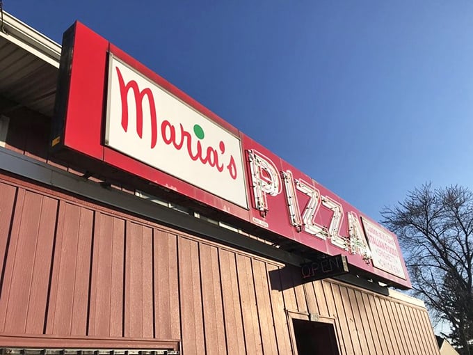 The sun sets, but Maria's sign glows eternal – promising pizza the way your grandparents enjoyed it, wonderfully unchanged.