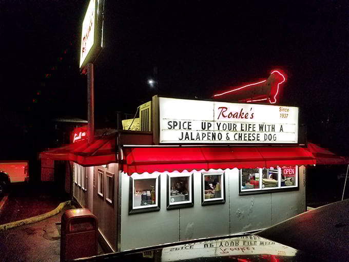 That neon sign at Roake's doesn't just advertise hot dogs—it's broadcasting a siren song of comfort food to weary travelers.