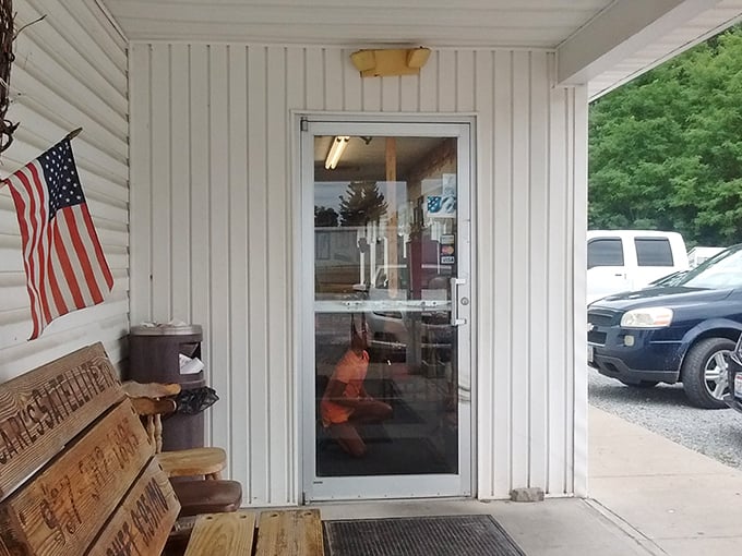 The American flag and wooden bench say it all—unpretentious, honest food served with small-town friendliness.