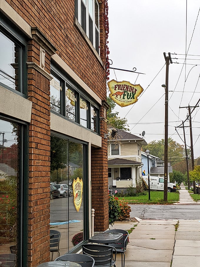 Peeking out from its brick façade, the Friendly Fox sign swings gently above a patio where sandwiches and conversation flow with equal ease.