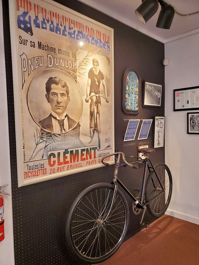 This vintage French cycling poster pairs perfectly with the antique bicycle below it—both capturing the elegant simplicity of early cycling culture.
