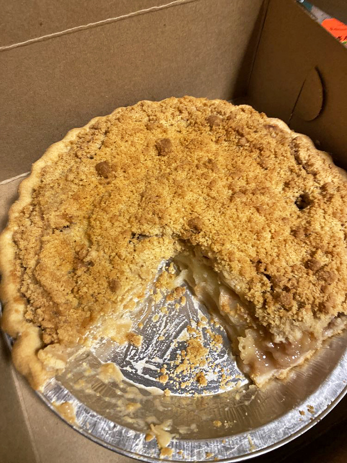 Apple pie that looks like it jumped straight out of a Norman Rockwell painting – complete with that "someone took a slice already" authenticity.