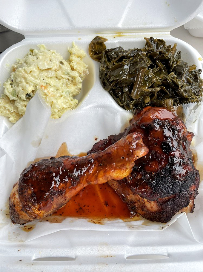 Chicken that proves barbecue isn't just a red meat game, flanked by collards and potato salad in perfect harmony. 