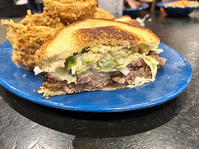 A sandwich built for serious eaters. Layers of smoked meat, slaw, and melted cheese between perfectly toasted bread—fork-optional but highly recommended.