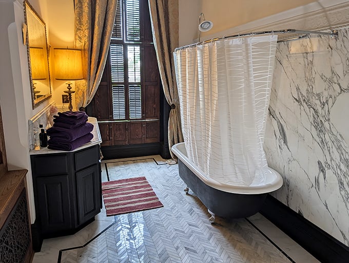 Even the bathroom exudes vintage charm with its clawfoot tub and marble walls—though you might want to shower with the curtain open.
