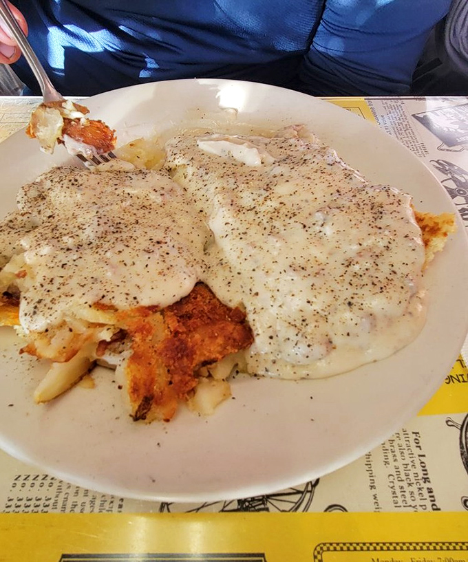 Biscuits swimming in gravy with a side of golden hashbrowns. Southern comfort meets Midwestern hospitality on a plate that could cure any ailment.