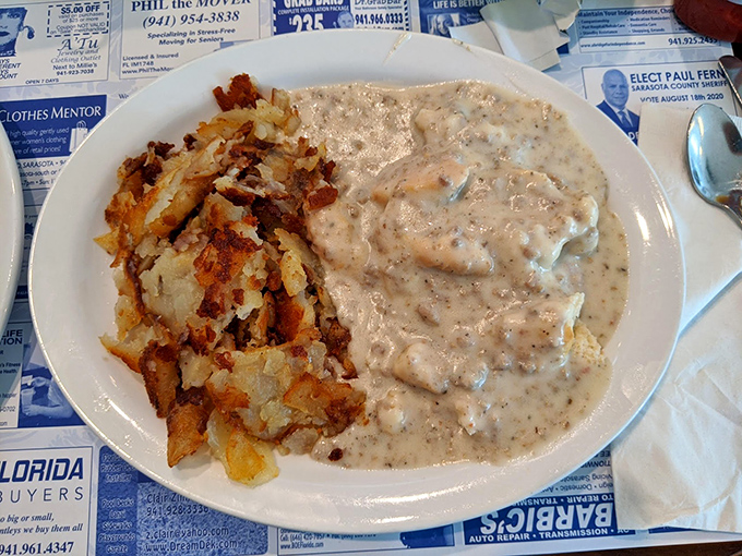 Biscuits and gravy that would make your Southern grandmother weep with joy—creamy, peppery perfection alongside potatoes crisped to golden glory.