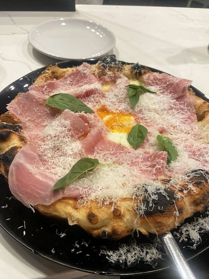 The Bismarck pizza—where prosciutto and egg create a breakfast-dinner mashup that makes you question why we even have meal categories.