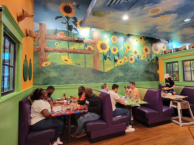 Beneath a ceiling of painted sunflowers, purple booths cradle diners in comfort while they tackle serious breakfast business.