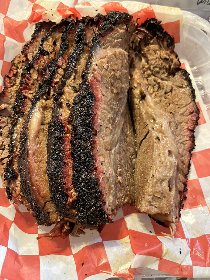 Brisket with a smoke ring so perfect it looks like it was engineered by NASA. The bark-to-meat contrast is basically poetry on a plate.