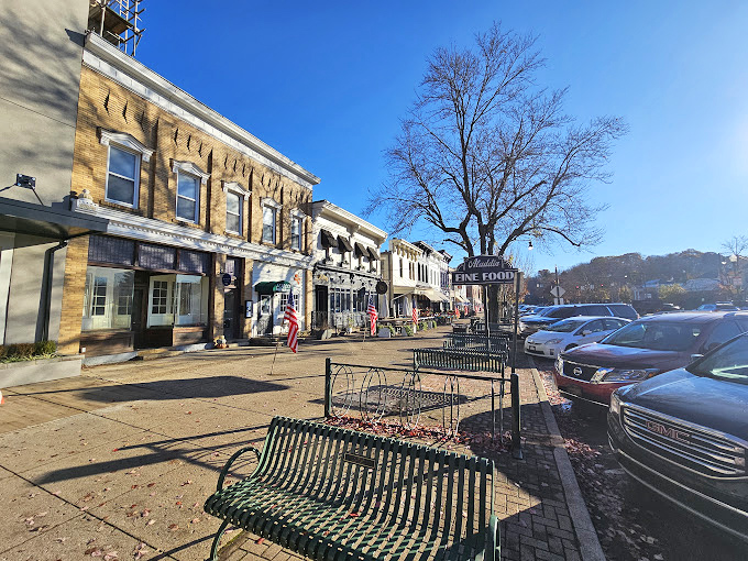 Winter sunshine bathes Broadway's historic storefronts, where benches await shoppers who need a moment to contemplate their next boutique conquest.