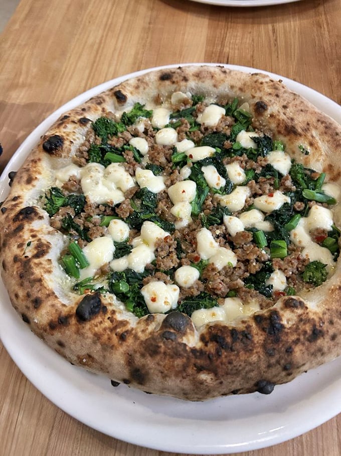 Sausage and broccoli rabe pizza—where spicy meets bitter, and both agree that this relationship, built on a perfect crust, was meant to be.