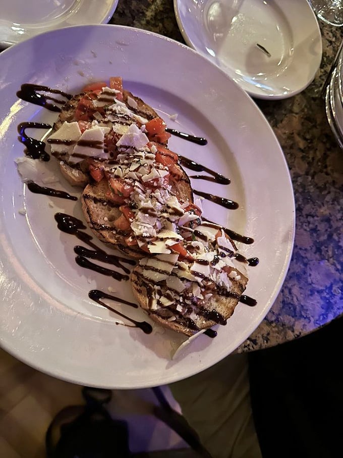Bruschetta that doesn't whisper "fresh"—it announces it with a megaphone of bright tomatoes and shaved parmesan.