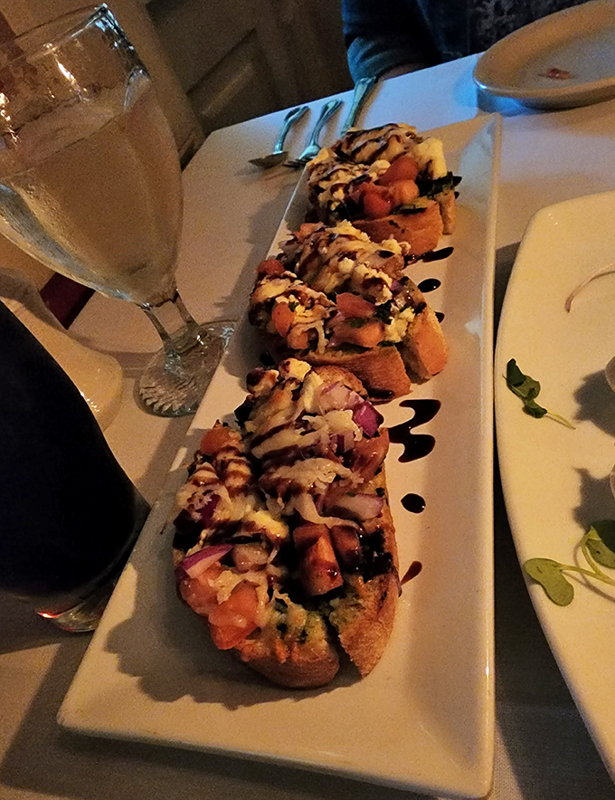 Bruschetta artfully arranged like edible confetti, each bite bursting with fresh Mediterranean sunshine and flavor.