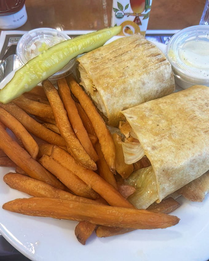 This wrap doesn't just contain lunch—it imprisons flavor in a tortilla fortress, with crispy fries standing guard and coleslaw providing cool reinforcement.