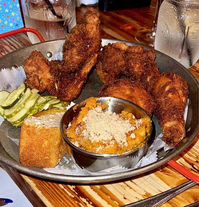 This isn't just fried chicken—it's edible artwork with a PhD in comfort food. That side of sweet potato something has me ready to book a table.