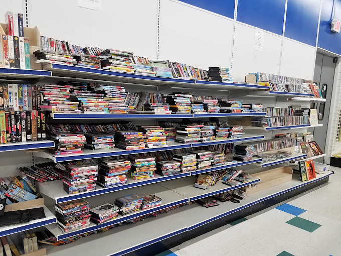 Musical time capsules and movie memories line these shelves, waiting for someone who appreciates physical media's enduring charm.