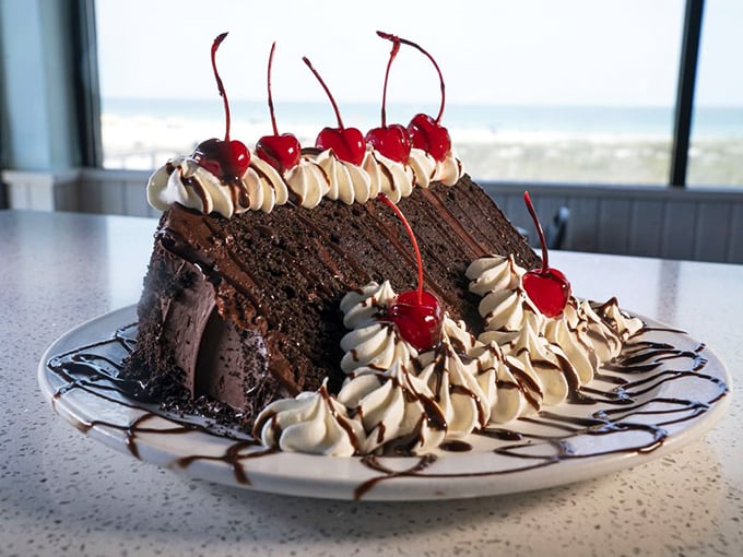 When a chocolate cake looks this decadent, it's not dessert—it's the grand finale your seafood feast deserves, complete with cherry standing ovation.