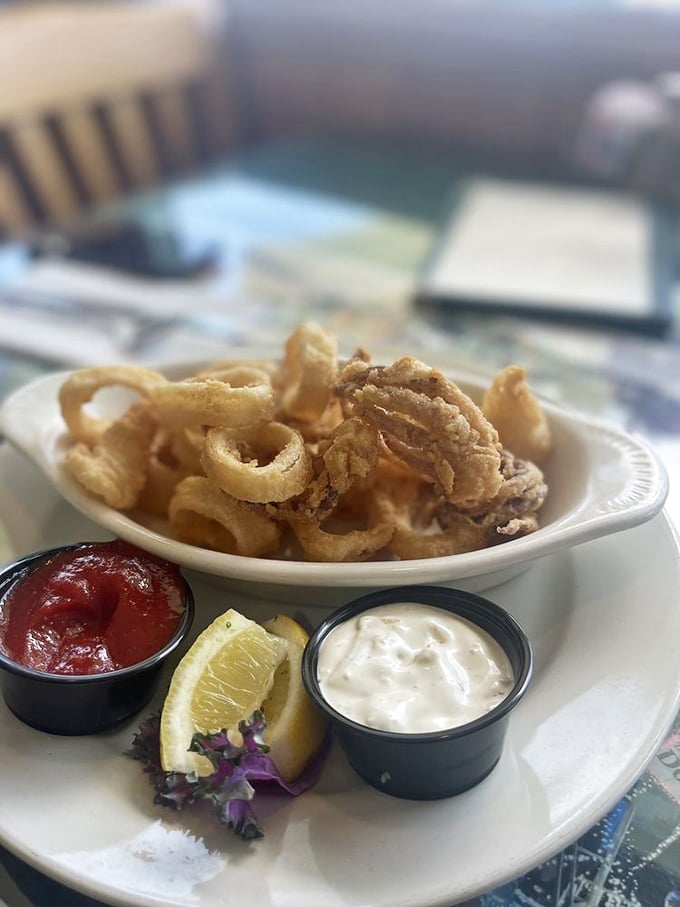 Crispy calamari that doesn't require the workout your jaw expects—tender rings served with house-made dipping sauces and a bright lemon wedge.
