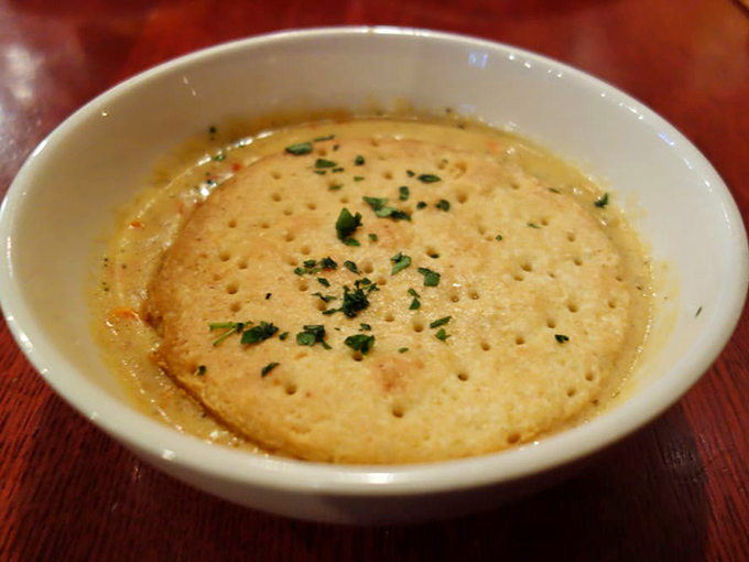 A chicken pot pie that doesn't just warm your stomach but hugs your soul, topped with a biscuit that's achieved perfect golden-brown enlightenment.