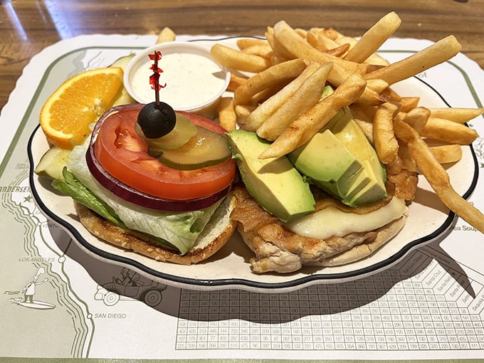 A perfectly constructed sandwich with golden fries—the kind of roadside meal that makes you grateful for hunger and the invention of bread.