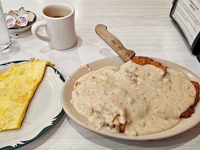 Country-fried steak swimming in pepper gravy alongside a perfect omelet. Breakfast for dinner or dinner for breakfast—rules don't apply here.