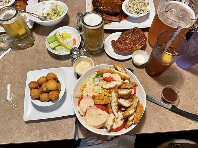 A table spread that would make any barbecue enthusiast weak at the knees. Those hush puppies are calling my name.