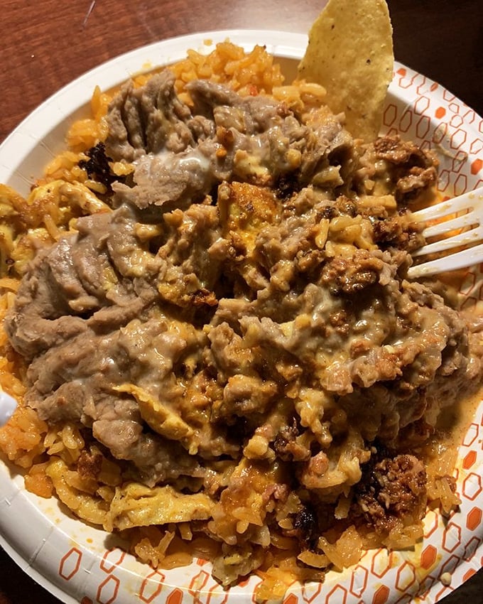 Chori pollo that doesn't just sit on the plate—it commands attention. That cheese sauce blankets the dish like a savory fog rolling over flavorful terrain.