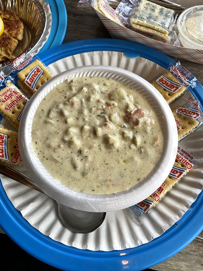 A chowder so comforting it could end family feuds, surrounded by crackers standing at attention, ready for their creamy bath.