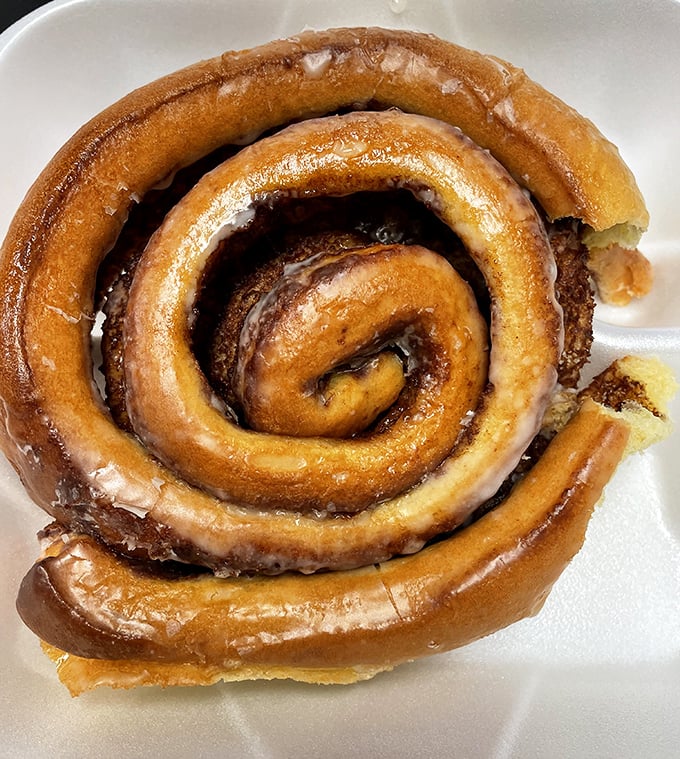 This cinnamon roll isn't just breakfast – it's a spiral-shaped journey to a simpler time when calories didn't exist on vacation.