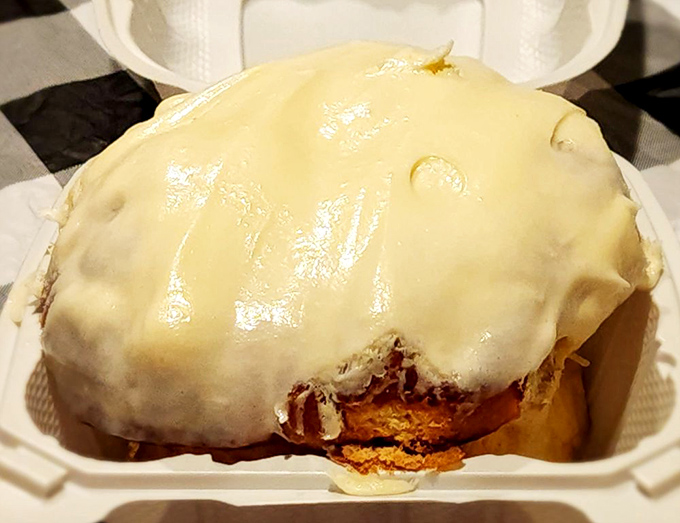 This cinnamon roll isn't just breakfast—it's dessert masquerading as a morning meal, wearing a cream cheese disguise that fools absolutely no one.