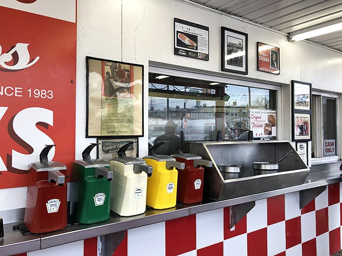 The condiment station—where personalization happens. Those colorful squeeze bottles hold the power to customize your sandwich destiny.