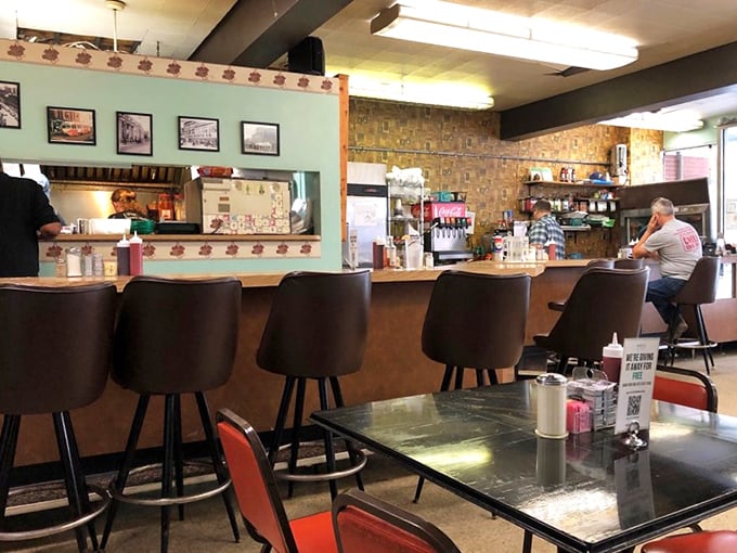 Counter seating where strangers become friends over shared appreciation for perfectly brewed coffee and conversation.