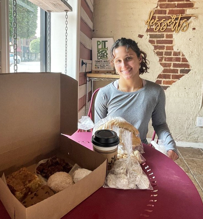 The joy of scoring the perfect pastry box is written all over this customer's face—a universal language of sweet anticipation.