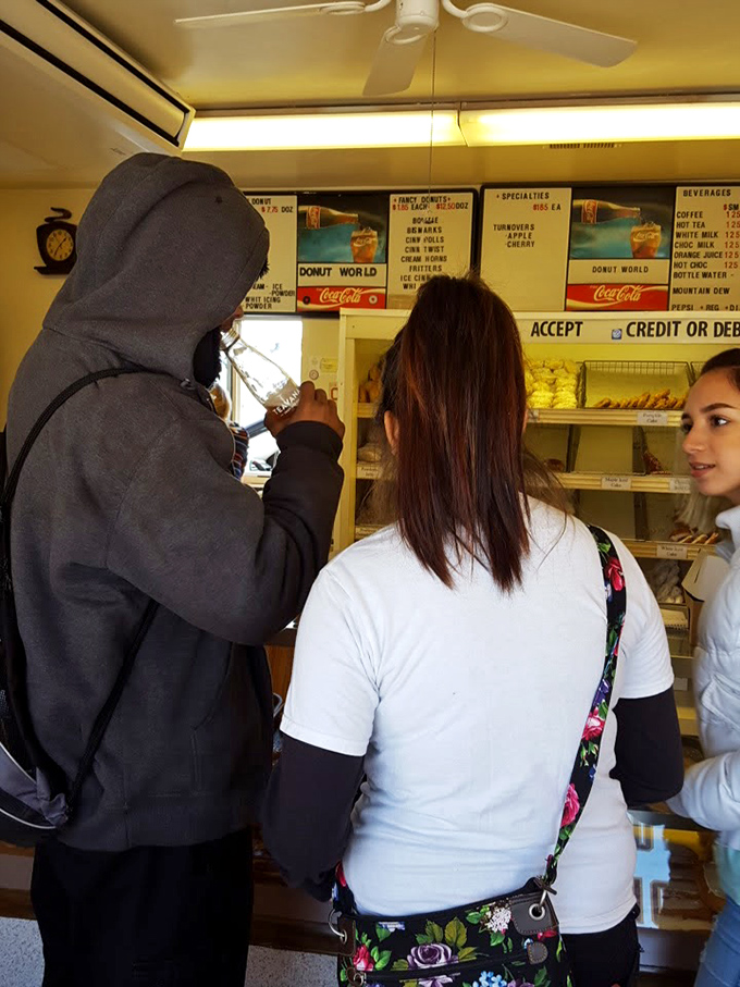 The universal language of donuts brings people together at the counter. No political divisions here—just the shared pursuit of sugary bliss.