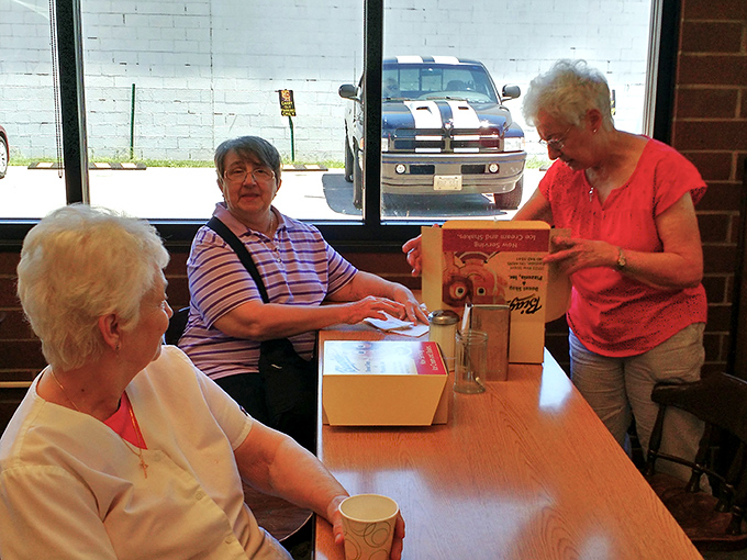 Three generations sharing donuts and stories - this is what community looks like in edible form.