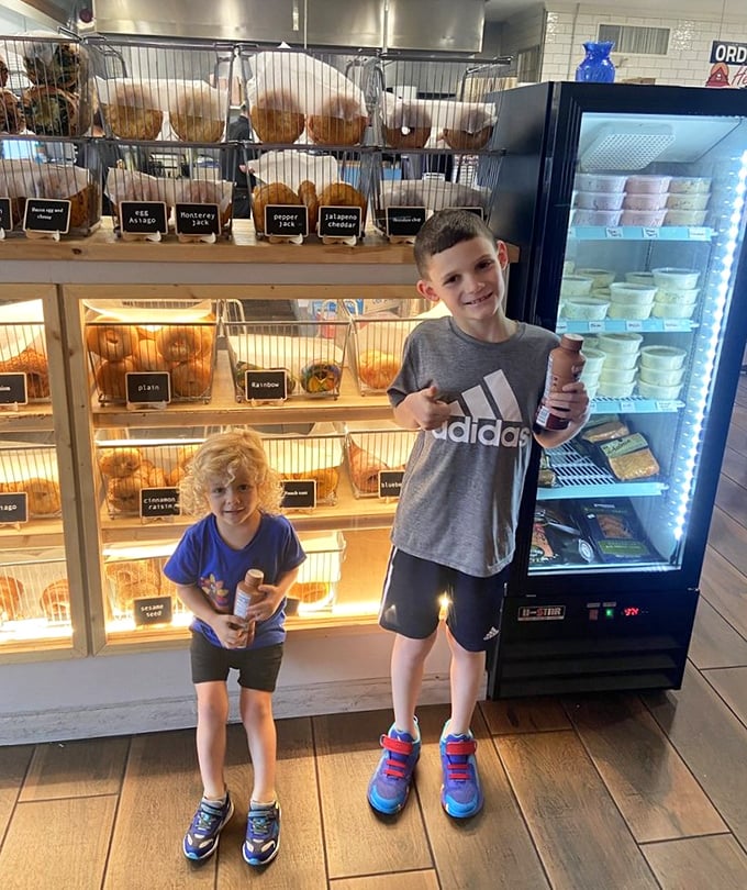 Young customers discovering the joy of fresh bagels—creating food memories that will last longer than any theme park souvenir.