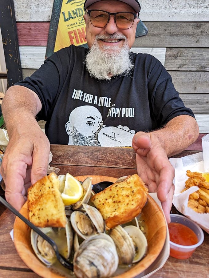 The joy of perfectly steamed clams and garlic bread is written all over this diner's face. This is what vacation memories are made of.