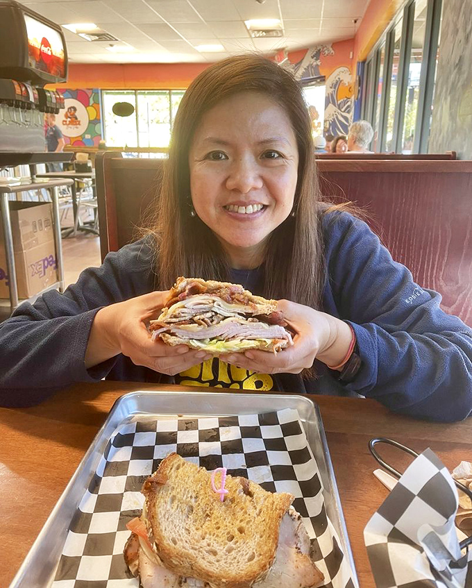 The joy of discovery is written all over her face. That sandwich isn't just lunch—it's the highlight of someone's Jacksonville adventure.