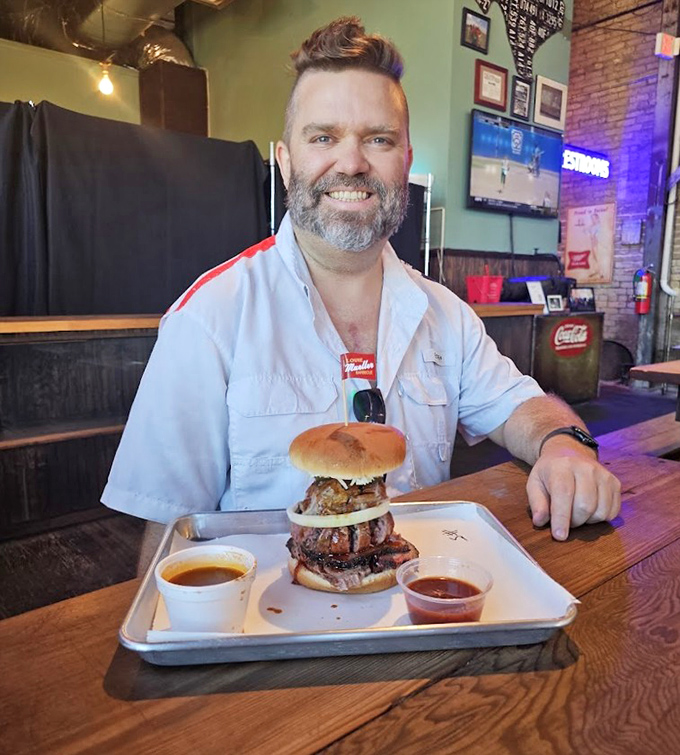 That smile says it all – the face of someone who's just discovered the meaning of life between two buns and a pile of smoked meat.