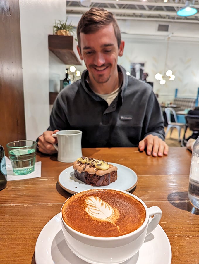 The joy of breakfast is written all over this scene—a perfect latte, a decadent pastry, and the anticipation of that first heavenly bite.
