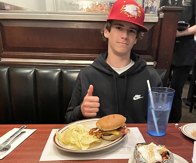 The universal thumbs-up: international symbol for "I've found barbecue worth driving across state lines for." Youth discovers what the elders already knew.